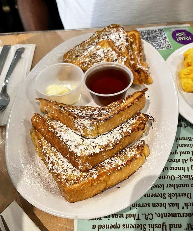 This French toast isn't just breakfast—it's an event. Golden-brown perfection dusted with powdered sugar, served with real maple syrup and a side of morning bliss.
