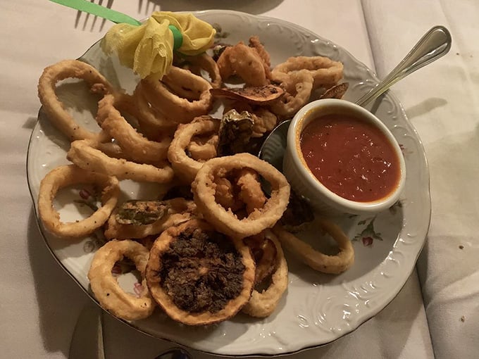 Golden, crispy perfection on a plate. This calamari isn't just fried—it's transformed into the reason you'll be planning your next visit before finishing your first.