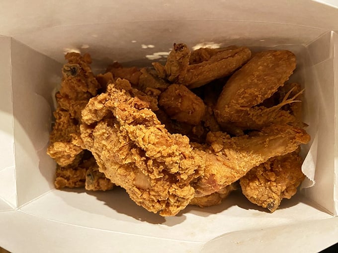 Golden-brown perfection in a takeout box. This isn't just fried chicken – it's edible nostalgia that makes you close your eyes on the first bite.