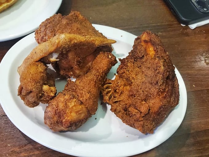 Golden-brown perfection that makes you want to write poetry. This fried chicken's crackling exterior guards juicy meat that's worth every napkin you'll need.