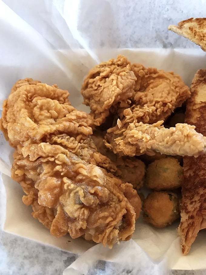 Golden-battered fried chicken that shatters with each bite, revealing juicy meat beneath—the kind that makes you close your eyes in silent appreciation.
