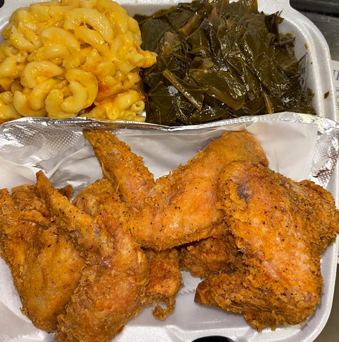 Golden-fried chicken that crackles with each bite, alongside mac and cheese that's practically glowing and collard greens cooked to silky perfection.