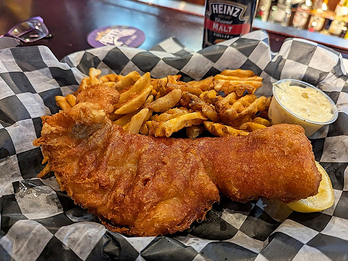 Behold the star of the show—golden-battered cod that breaks apart in delicate flakes, paired with crispy fries and house-made tartar sauce.