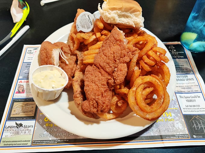 Golden perfection on a plate – this fried fish arrives with onion rings that could make you forget your own name.
