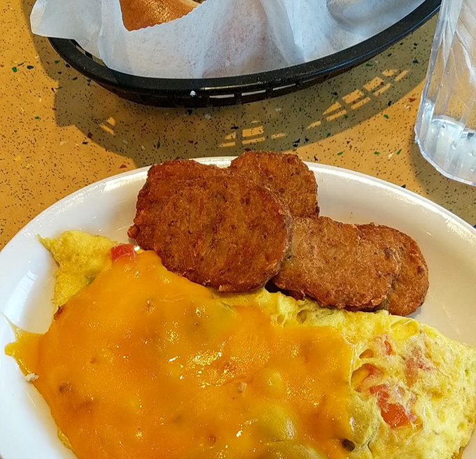 Golden-brown fried green tomatoes alongside a cheesy omelet—proof that Southern comfort and deli traditions can create the perfect breakfast marriage.
