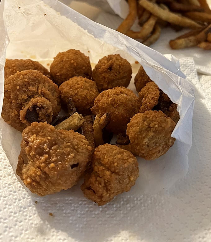 These golden-brown fried mushrooms aren't trying to be truffle pommes soufflés; they're proudly themselves—crispy, earthy bites of pure roadside joy.