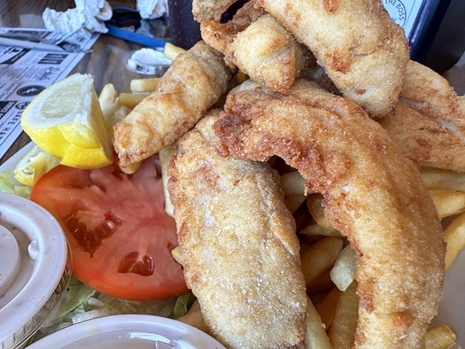 Golden-fried perch that shatters with each bite, revealing sweet, tender flesh that makes you wonder why you'd ever eat anything else on this island.