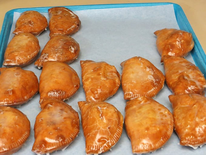 Golden-brown fried pies lined up like edible postcards from heaven. Each crimped edge promises the perfect ratio of flaky crust to fruit filling that makes diets spontaneously combust.