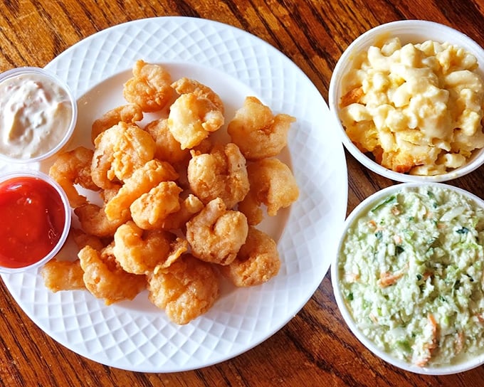 Golden-fried shrimp that crackle with each bite, flanked by creamy mac and cheese and coleslaw—a trio that could make a seafood lover weep with joy.