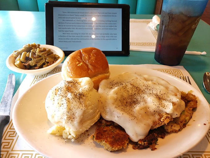 Country fried steak smothered in gravy with a side of green beans—a plate that whispers "take a nap afterward" but is worth every delicious minute of food coma.
