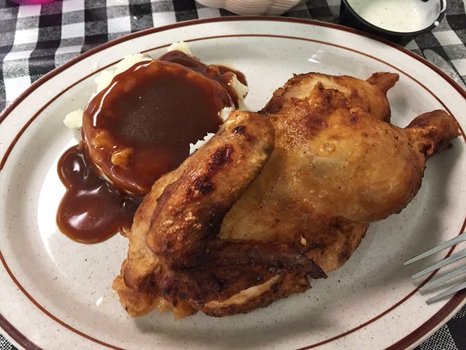 Fried chicken so perfectly golden it deserves its own trophy. That gravy pool isn't just sauce—it's a flavor lagoon waiting to be explored.