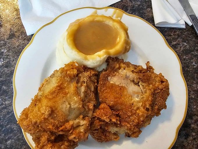 Golden-brown fried chicken with a crater of gravy-filled mashed potatoes – a plate that makes you wonder why you'd ever waste time eating anywhere else.