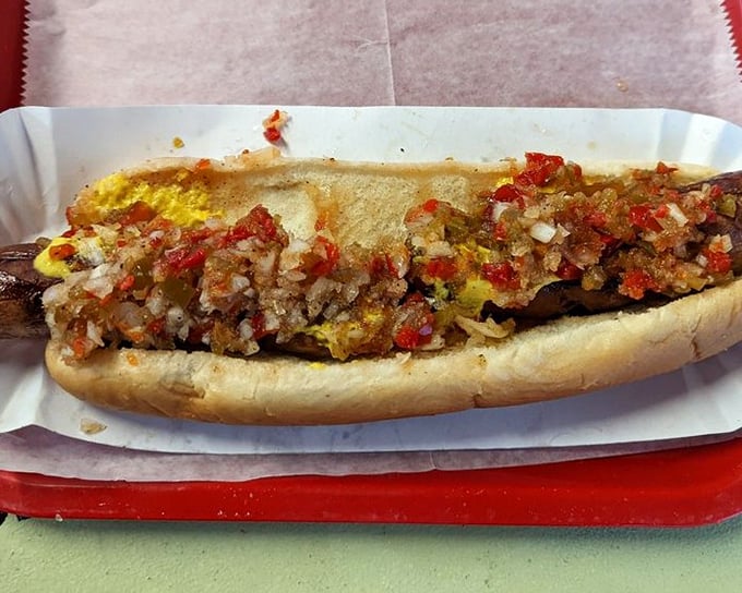 This isn't just a hot dog – it's a masterpiece of meat, mustard, and minced onions nestled in a soft bun that's worth every napkin you'll need.