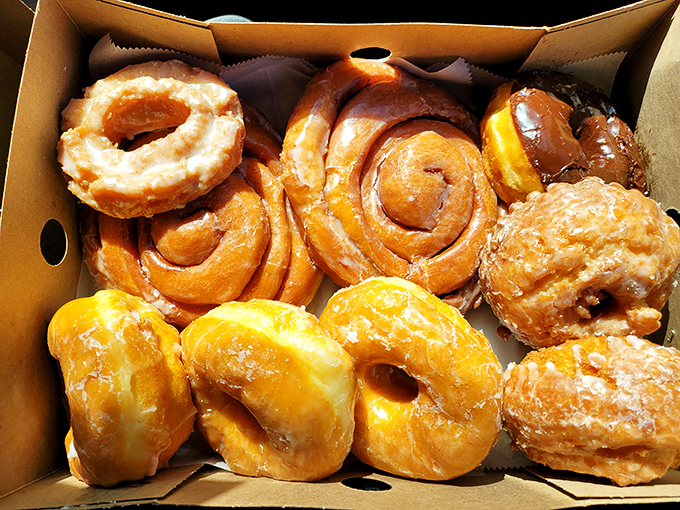 Donut nirvana in cardboard form. That golden-brown perfection isn't just breakfast—it's an edible hug for your taste buds.