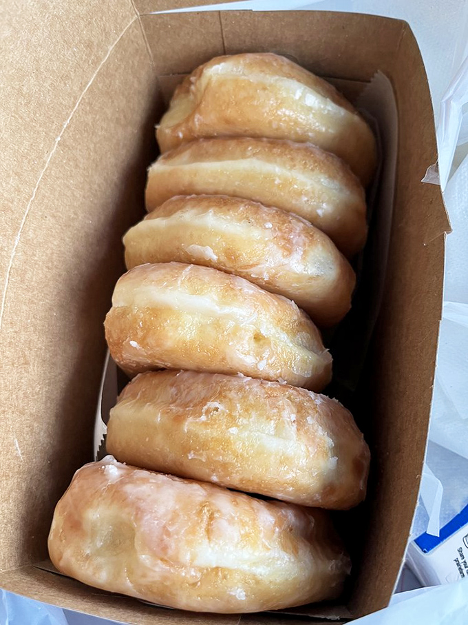 Golden pillows of perfection lined up like edible dominos. These glazed donuts aren't just breakfast—they're an Indianapolis rite of passage.