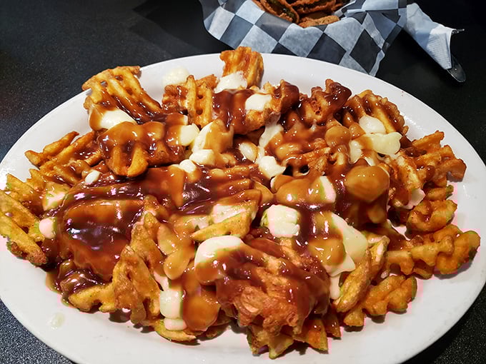 Behold the legendary gravy fries in all their glory! Golden waffle fries smothered in rich gravy and cheese curds—a plate that demands both a fork and your undivided attention.