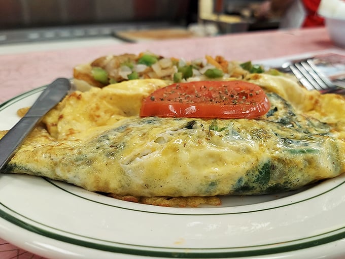 Behold the legendary Greek omelet—a perfect harmony of eggs, feta, and vegetables that might just make you consider relocating to Altoona.