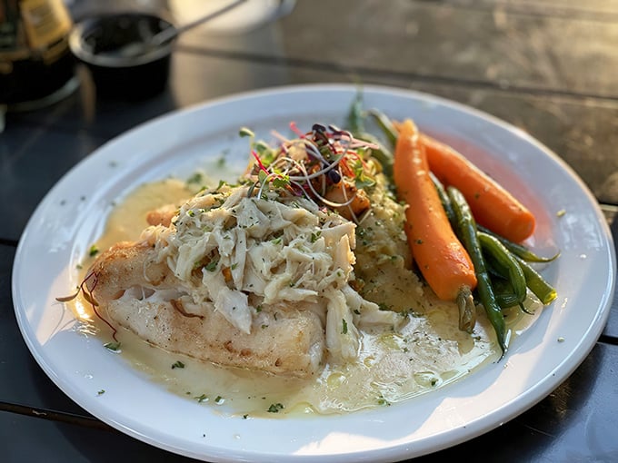 Behold the grouper that launched a thousand road trips – perfectly seared and accompanied by colorful seasonal vegetables.