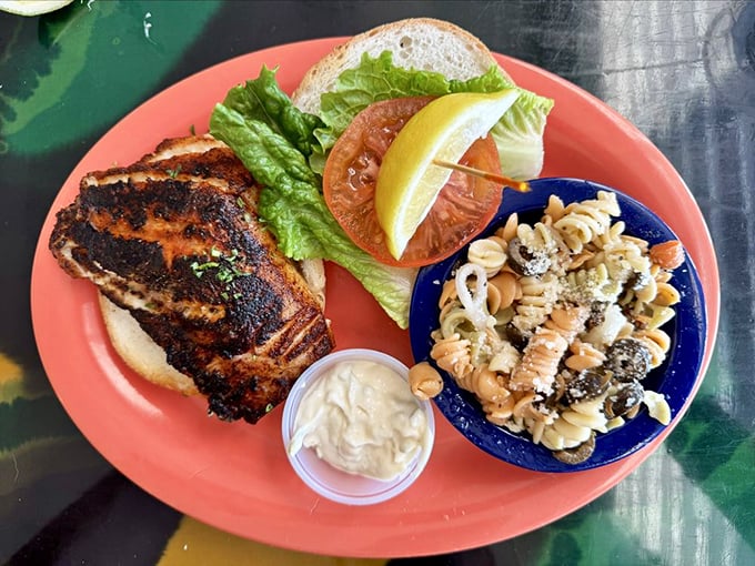 Behold the legendary grouper sandwich – blackened to perfection with pasta salad that deserves its own fan club.