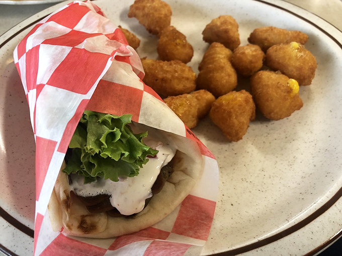 This isn't just a wrap—it's a handheld masterpiece of flavors, perfectly complemented by those golden-brown tater tots that crunch just right.