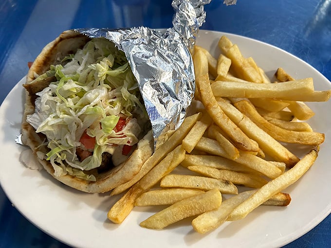 This isn't just any gyro – it's a masterpiece of tender meat, fresh veggies, and that signature tzatziki sauce that'll haunt your dreams for weeks.