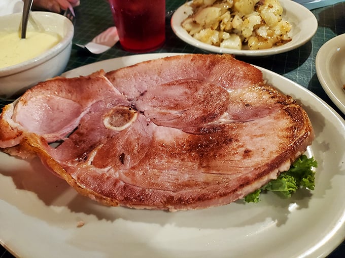 The legendary ham steak arrives like a pink meteor that crashed onto your plate from Pork Heaven. This isn't food; it's an event.