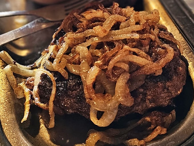 This isn't just any hamburger steak—it's a masterpiece of Midwestern comfort, crowned with crispy onions that add the perfect textural counterpoint.