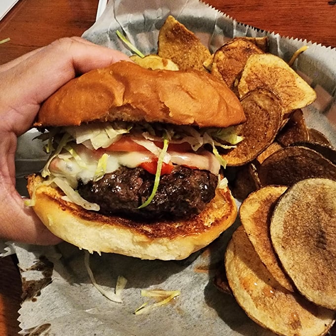 This isn't just a hamburger—it's a juicy masterpiece demanding two hands and your full attention. Those house-made kettle chips aren't playing second fiddle to anyone.