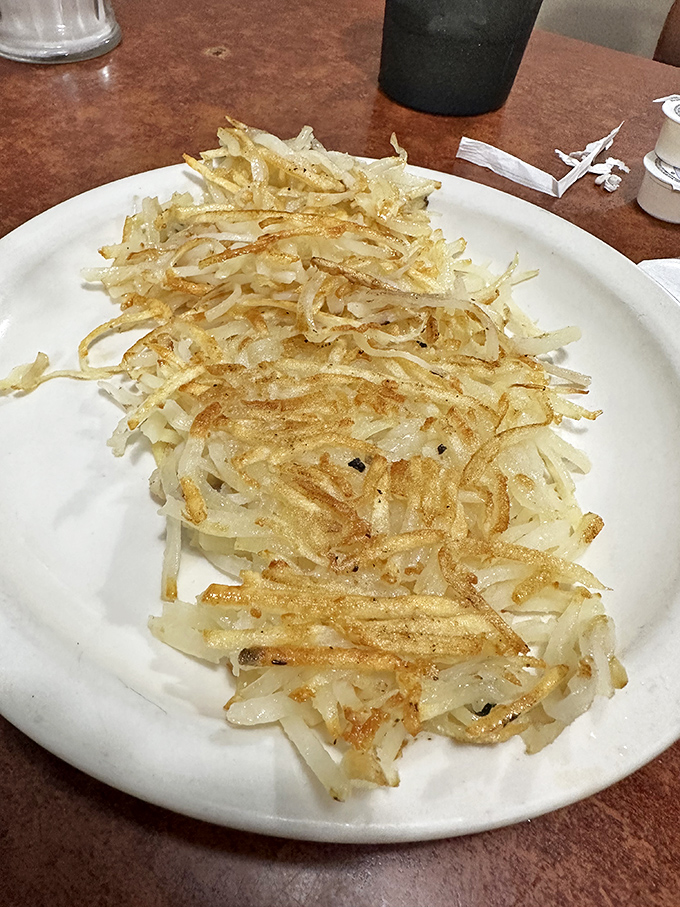 These hash browns deserve their own zip code – crispy, golden perfection that makes you wonder why anyone would ever eat potatoes any other way.