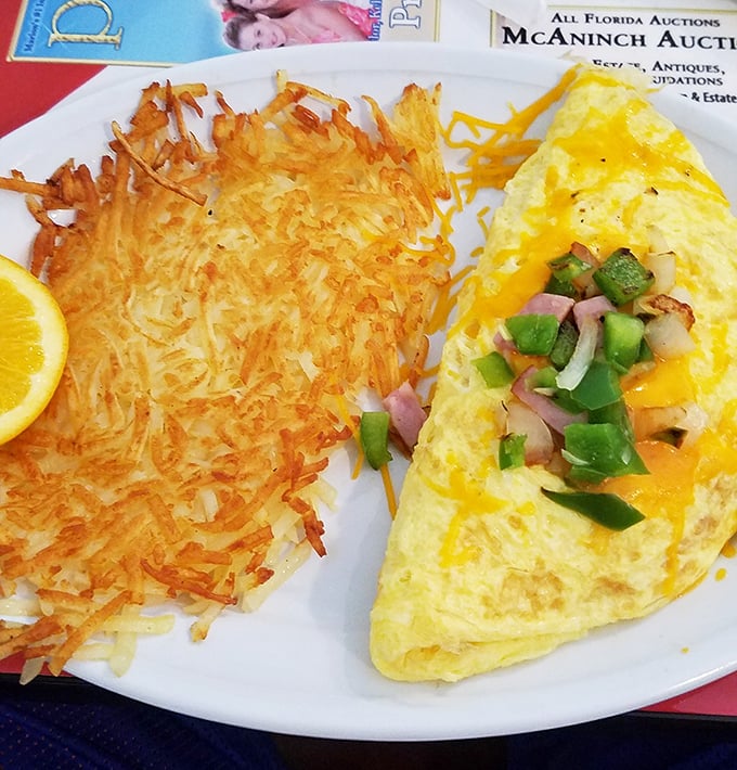 Geometry teachers would approve—a perfect triangle of cheese-laden omelet meets its crispy hash brown soulmate. Morning mathematics never tasted so good.