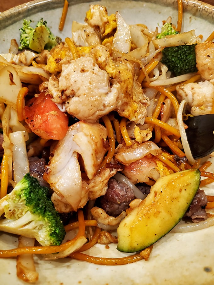 This hibachi creation isn't just food—it's a colorful masterpiece where chicken, beef, and vegetables perform a delicious symphony on your plate.