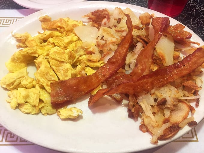 The holy trinity of breakfast: perfectly scrambled eggs, bacon cooked to that magical crisp-yet-chewy state, and home fries that could make a potato proud.