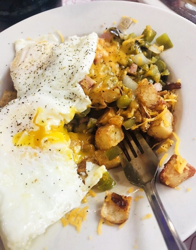 Breakfast bowls don't get more photogenic than this—crispy home fries mingling with peppers and melted cheese, crowned with perfectly cooked eggs that ooze sunshine when pierced.