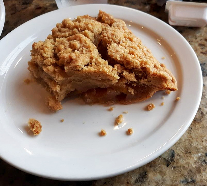 This isn't just apple pie—it's edible architecture with a crumb topping that would make your grandmother simultaneously proud and jealous. Worth every calorie.