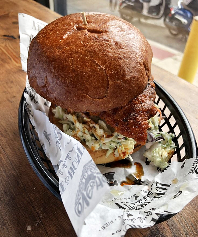 Behold the Nashville Hot Chicken Sandwich in all its glory—a masterpiece of crunch, heat, and slaw that makes other sandwiches question their life choices.