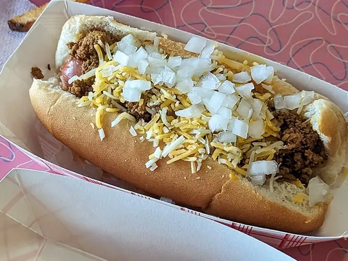 This isn't just a chili dog—it's an edible history lesson. Topped with enough cheese and onions to make your cardiologist wince but your taste buds applaud.