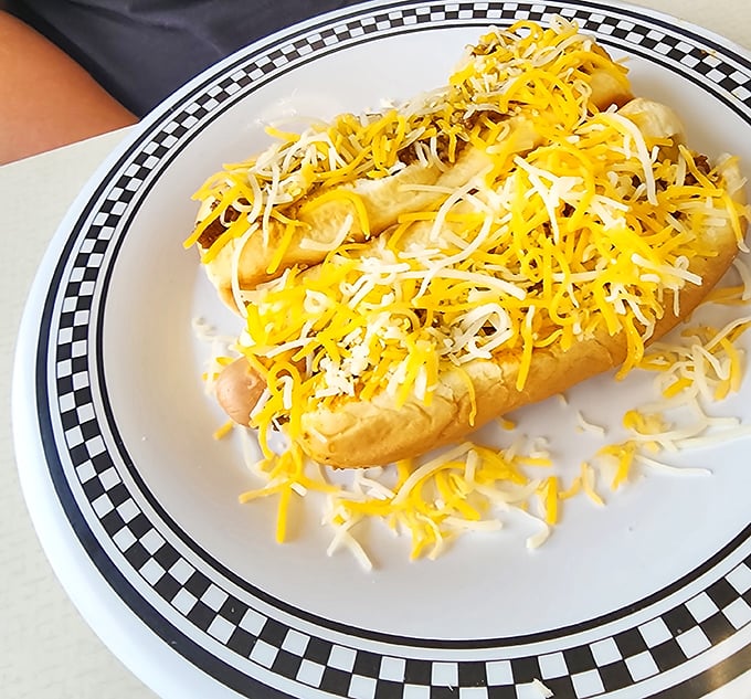 Cheese lovers, rejoice! This coney dog comes blanketed in a snowstorm of shredded cheese that would make even Wisconsin nod in approval.