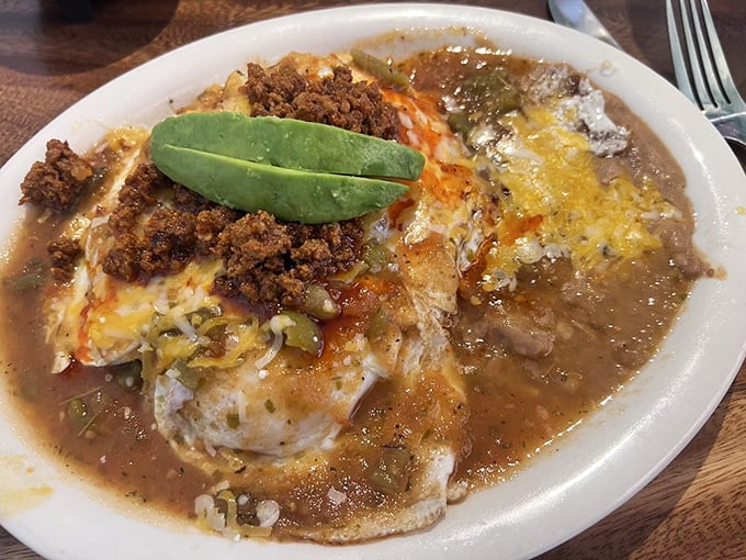 Huevos Rancheros: where eggs meet their destiny. That avocado slice isn't just a garnish—it's the emerald crown jewel of this breakfast masterpiece.