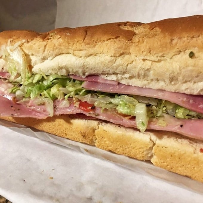 Layer upon layer of Italian meats and fresh veggies nestled in crusty bread—this isn't just lunch, it's an edible architecture project.