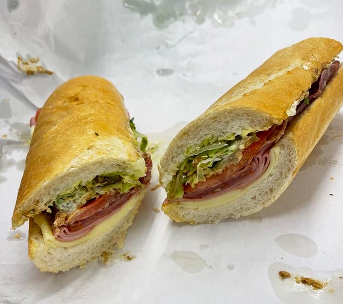 This isn't just a sandwich; it's edible architecture. Layers of Italian meats and fresh toppings nestled in that legendary coal-fired bread.