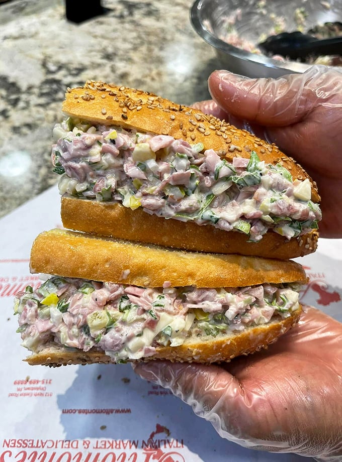 Sandwich architecture at its finest. This ham salad creation on seeded Italian bread isn't just lunch—it's the reason people drive across county lines.