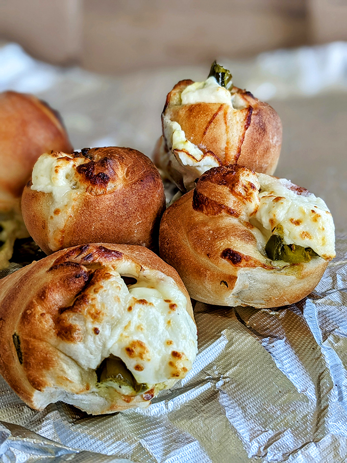 These aren't your average jalapeño poppers—they're golden-brown flavor bombs where crispy exteriors give way to molten cheese-filled peppers.