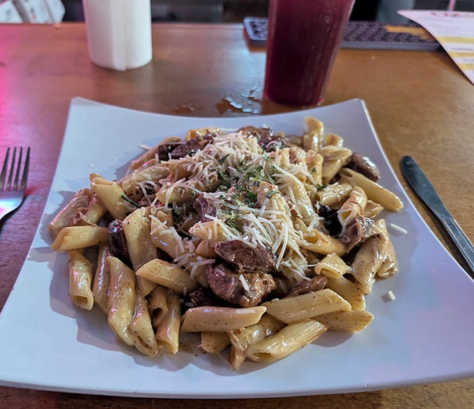 The legendary jambalaya pasta arrives like a celebrity—penne swimming in creamy sauce with chunks of chicken and sausage that'll make your taste buds stand up and applaud.