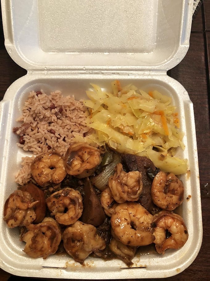 The star of the show: jerk shrimp nestled against rice and peas with cabbage—a styrofoam container of pure Caribbean joy.