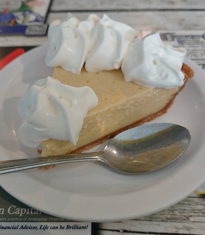 This key lime pie achieves dessert nirvana – tart, sweet, and crowned with clouds of whipped cream perfection.