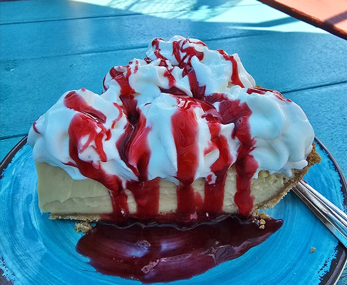 This isn't just key lime pie – it's a sweet-tart masterpiece crowned with whipped cream and berry sauce that would make Jimmy Buffett write a whole new verse.