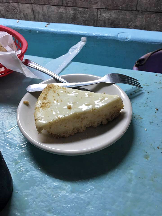 Key lime pie that makes time stand still. That pale yellow hue signals authenticity—no food coloring here, just pure, tangy-sweet Florida sunshine transformed into creamy perfection.