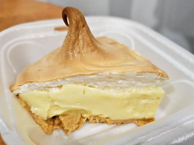 This slice of key lime pie isn't just dessert; it's Florida's soul on a plate—tart, sweet, and topped with a meringue peak that demands a moment of silent appreciation.