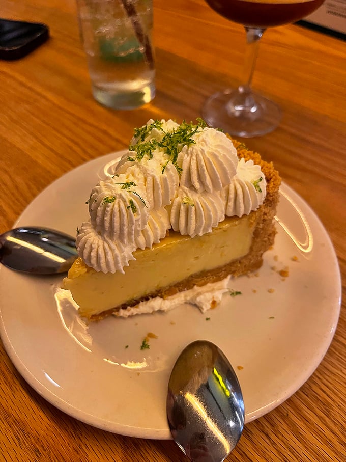 The key lime pie that launched a thousand return visits—creamy, zesty perfection topped with pillowy whipped cream and lime zest.