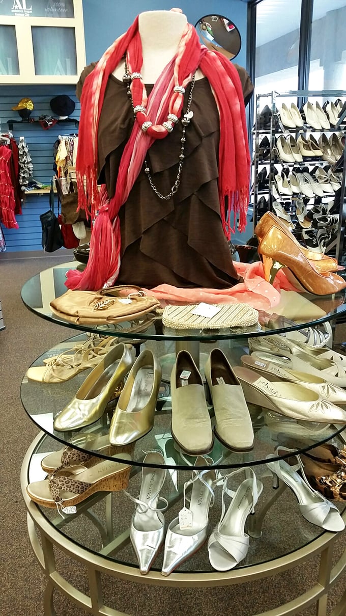 Shoe heaven exists, and it's arranged on elegant glass tiers. That brown dress with the coral scarf is just waiting for its Cinderella moment.